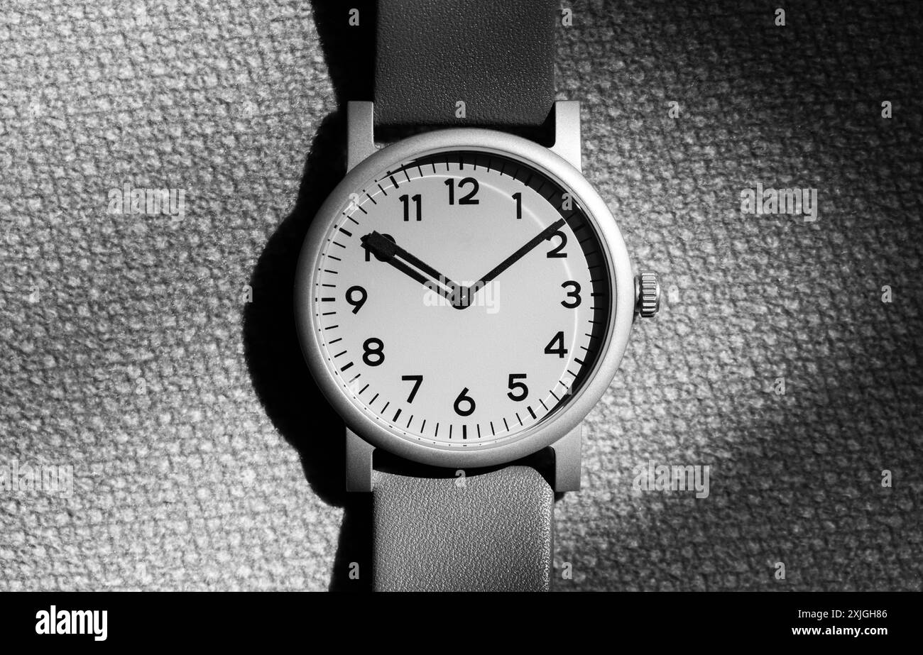 Two-hand mechanical wrist watch with gray clock face and black Arabic ...