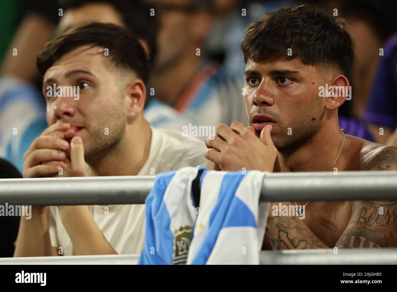 Argentina’s fans watch their team play and show gestures of anguish and ...