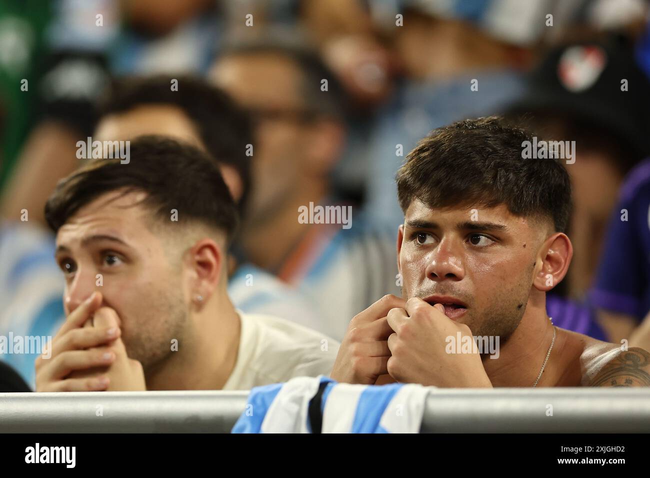 Argentina’s fans watch their team play and show gestures of anguish and ...