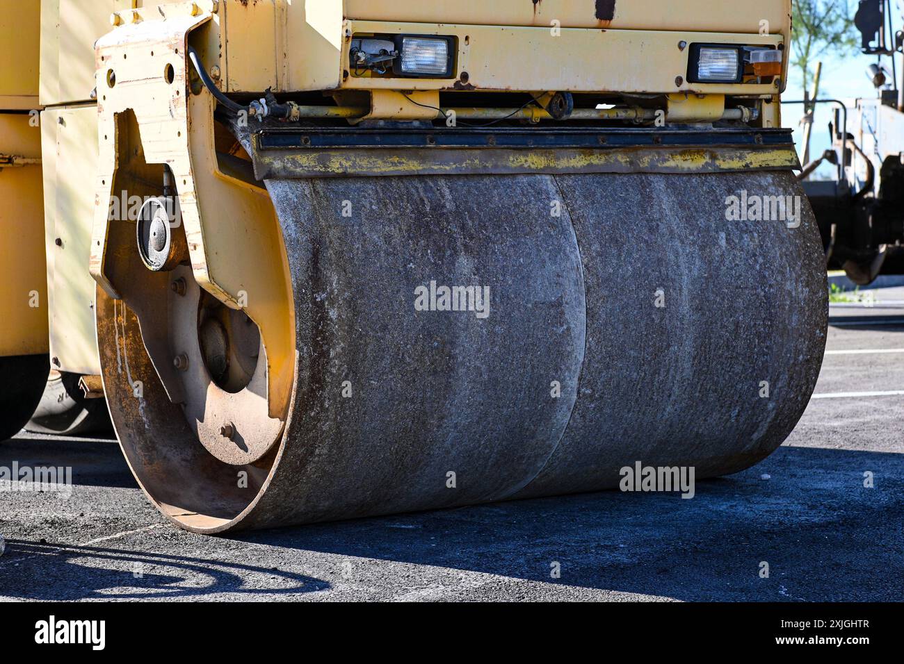 Heavy vibration single drum roller compactor working on asphalt road ...