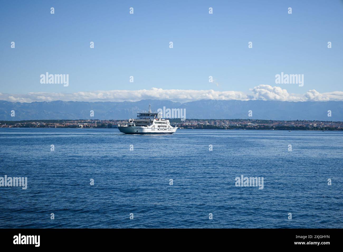 A ferry sailing across the Adriatic Sea to a Croatian island with ...