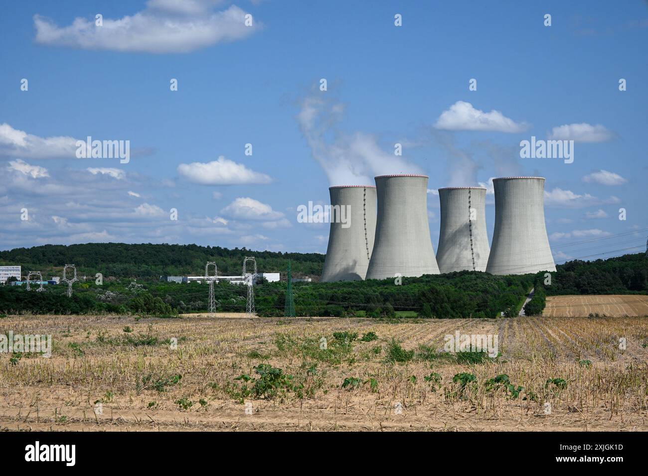 Four large nuclear power plant cooling towers releasing steam into the ...