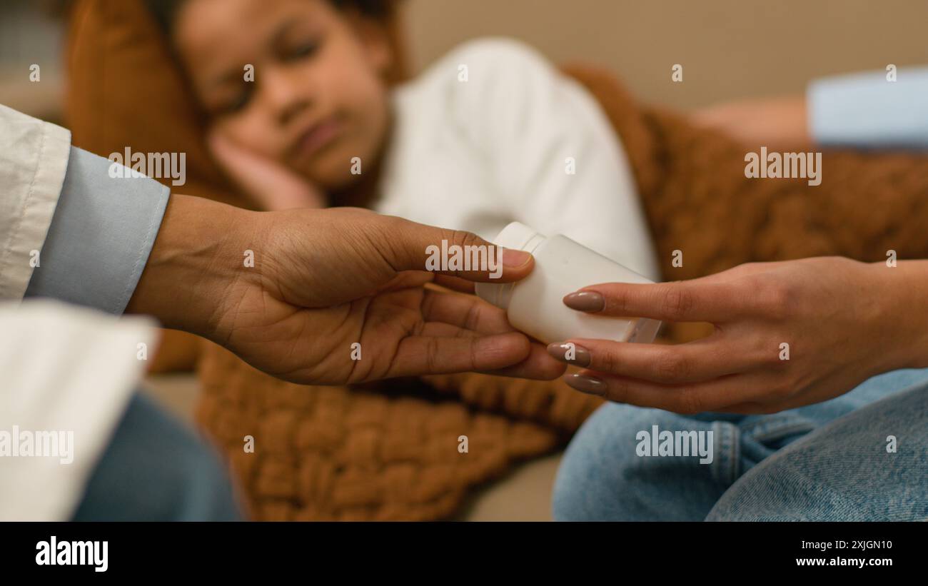 Close up hands doctor give drug pills mother parent illness virus ...