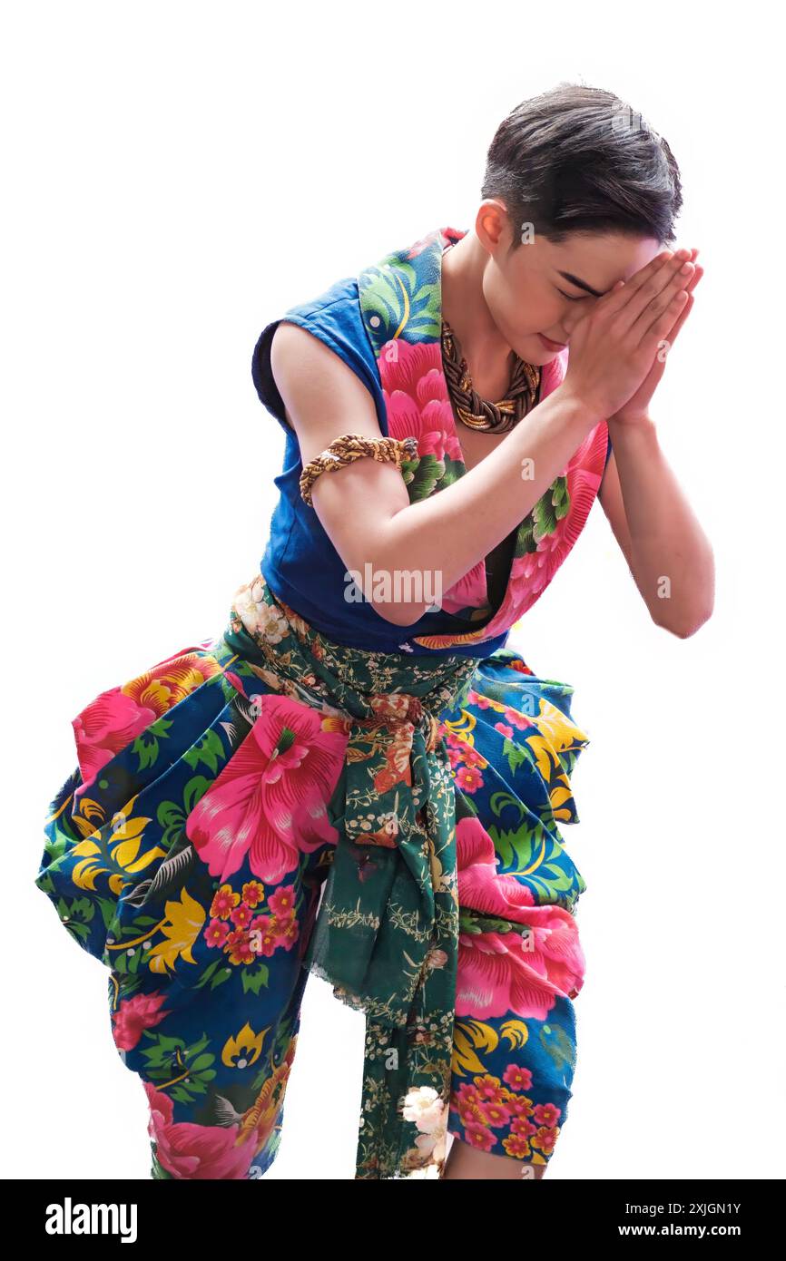 Thai male classical dancer in bright coloured costume wais while ...