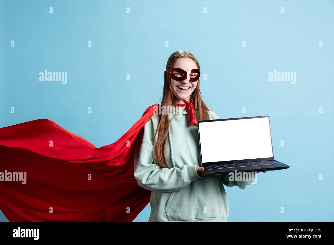 Portrait of happy teenager with mask laughing while holding mockup ...