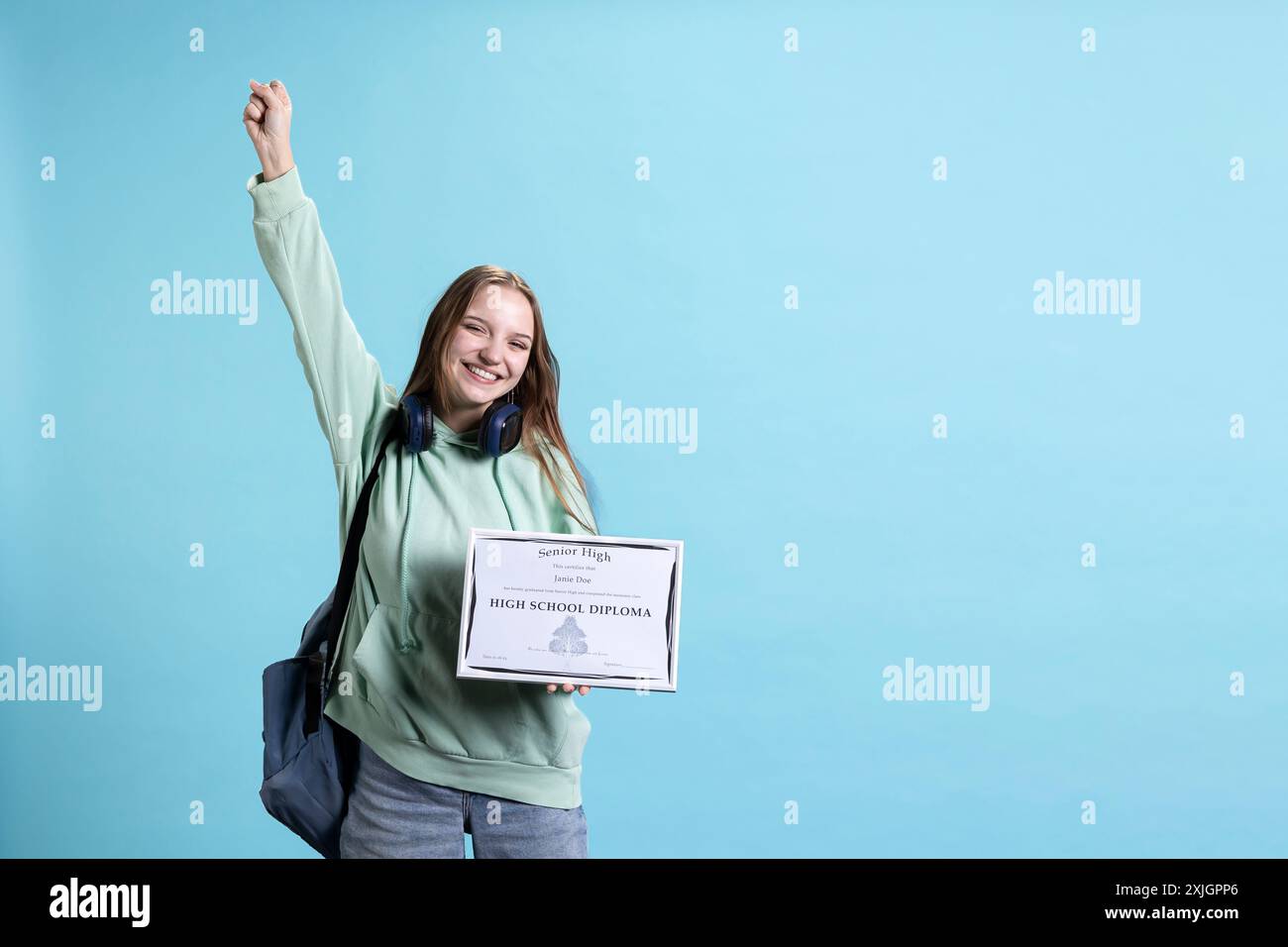 Portrait of smiling student holding high school diploma, feeling ...