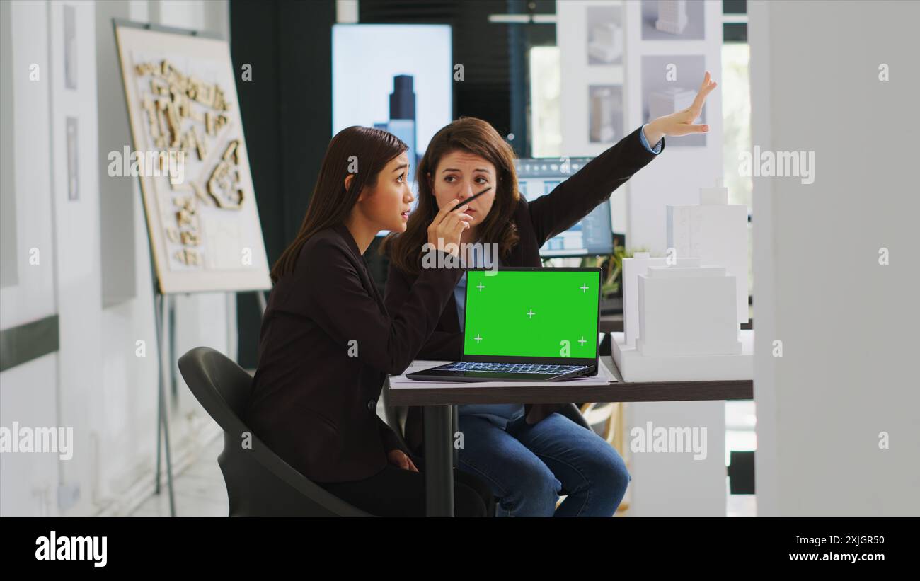 Team of architects working with greenscreen layout on pc, planning new ...