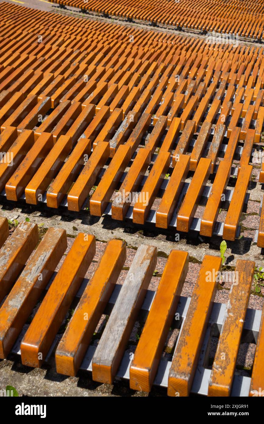Brown wooden benches in the city amphitheater. Close up of the rungs ...