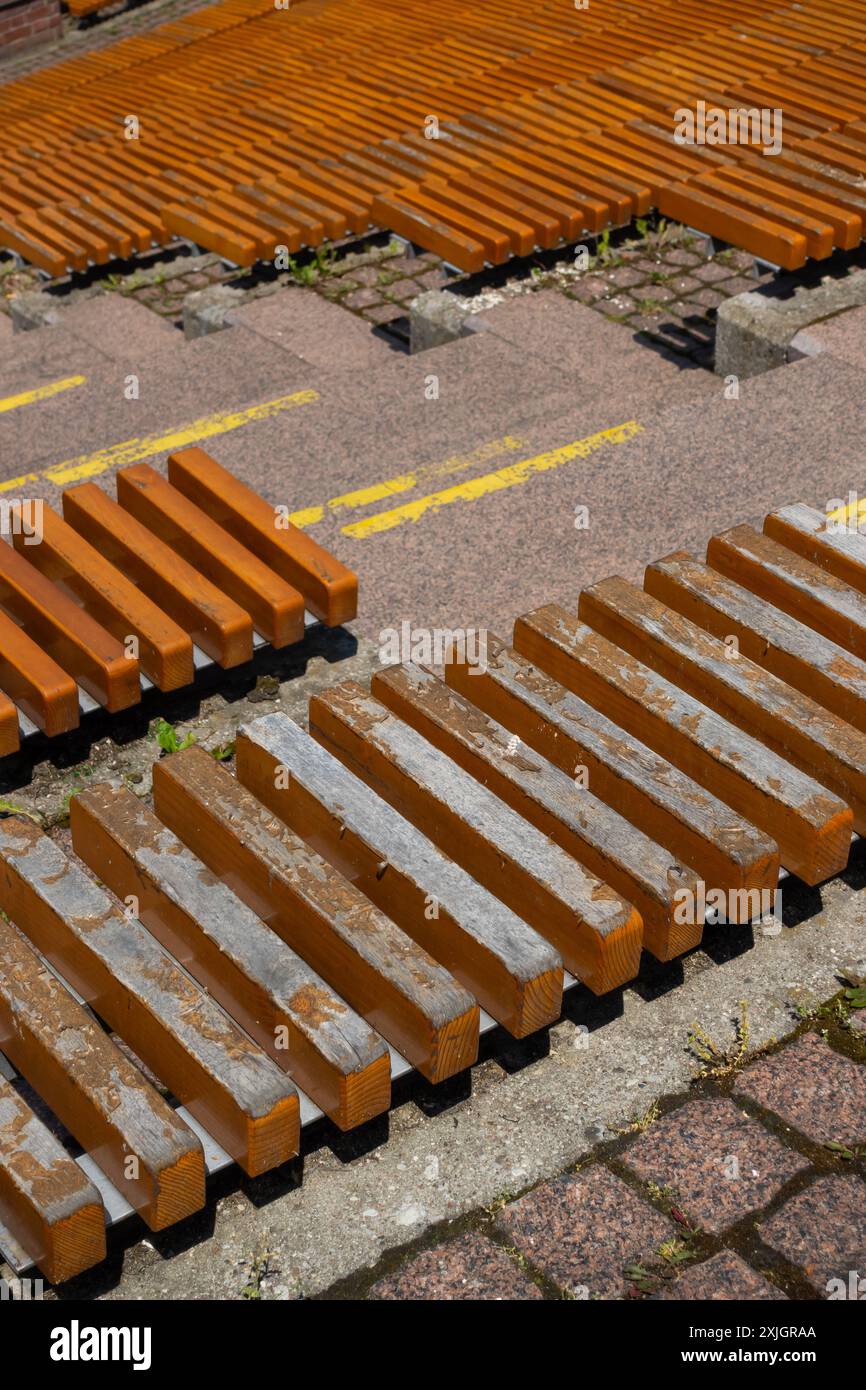 Brown wooden benches in the city amphitheater. Close up of the rungs ...
