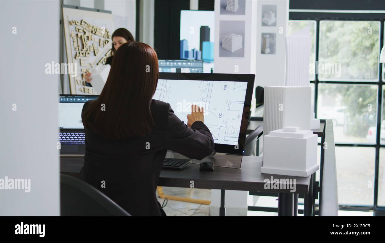 Developer sketching remodeling plan lines on touch screen pc, working ...