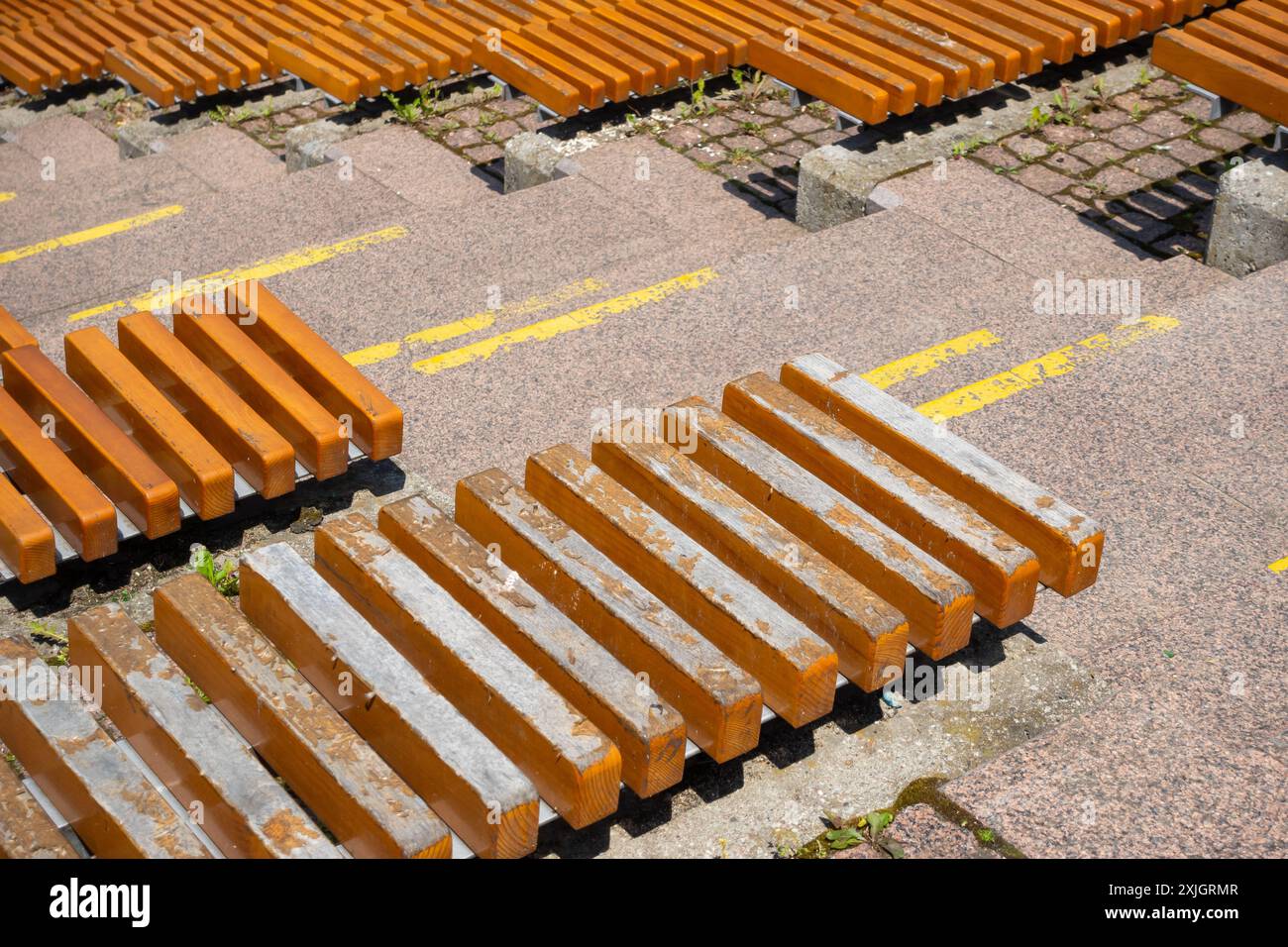 Brown wooden benches in the city amphitheater. Close up of the rungs ...