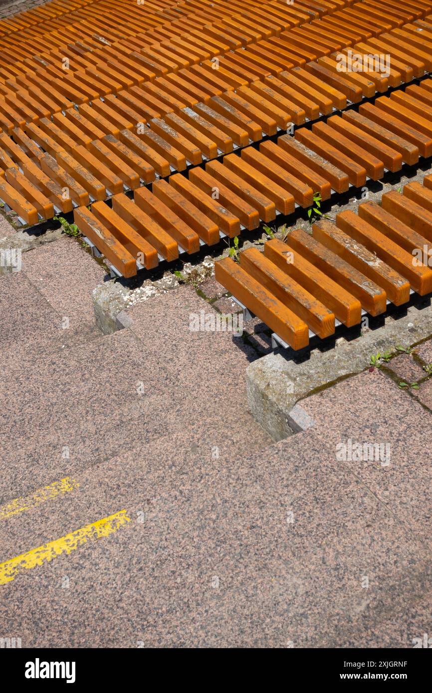 Brown wooden benches in the city amphitheater. Close up of the rungs ...