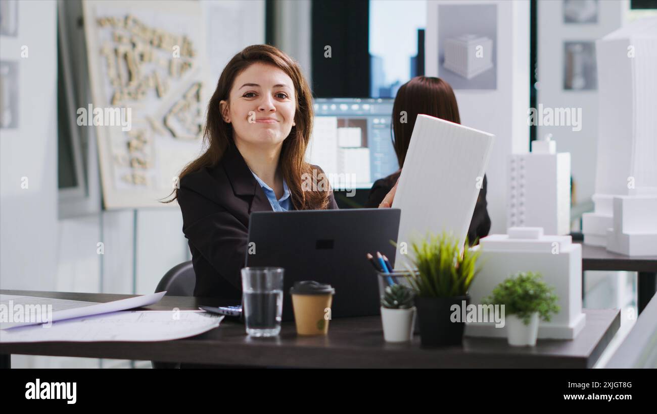 Portrait of architect examines 3d model scale to gather dimensions and ...