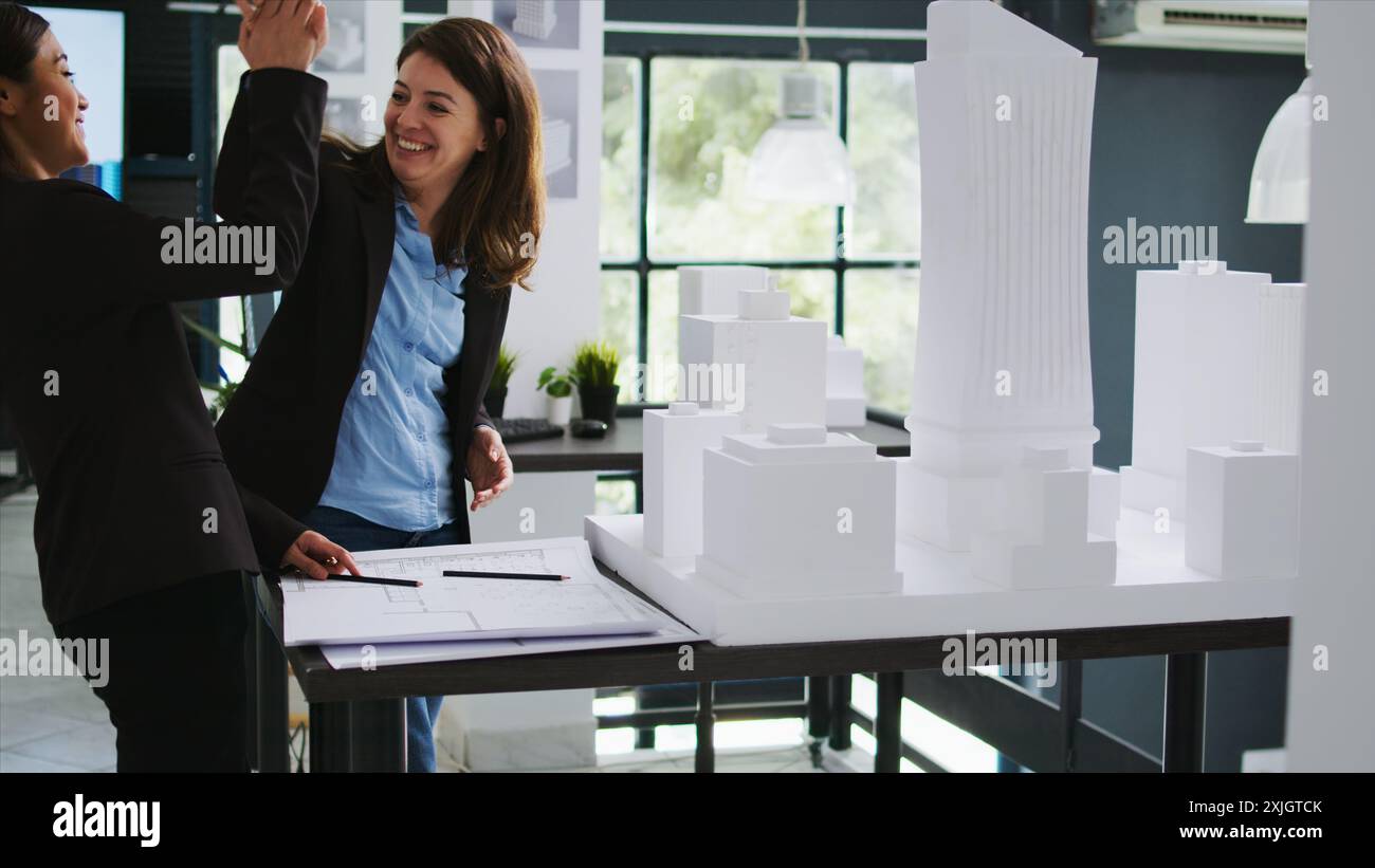 Architects team sharing high five after making progress with their ...