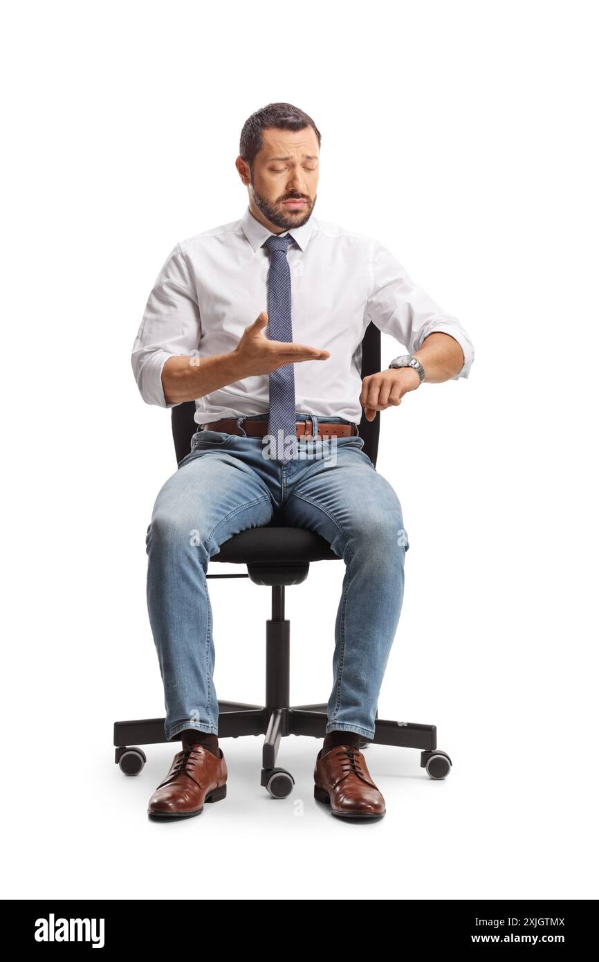 Professional man sitting in an office chair and checking time on watch ...