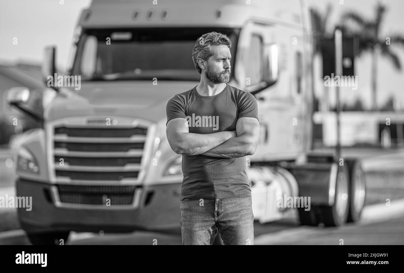 Trucking owner. hispanic man posing in front of truck. Semi trucks ...