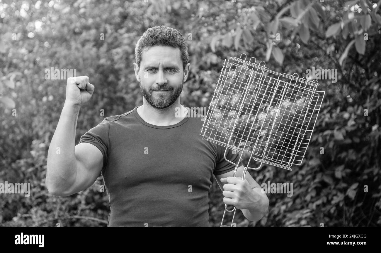 photo of strong man with barbecue grill. man with barbecue grill. man ...