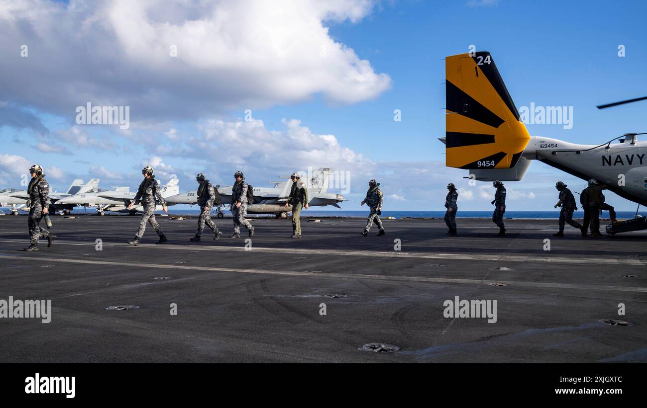 Members of the Australian navy depart a CMV-22B Osprey, assigned to the ...