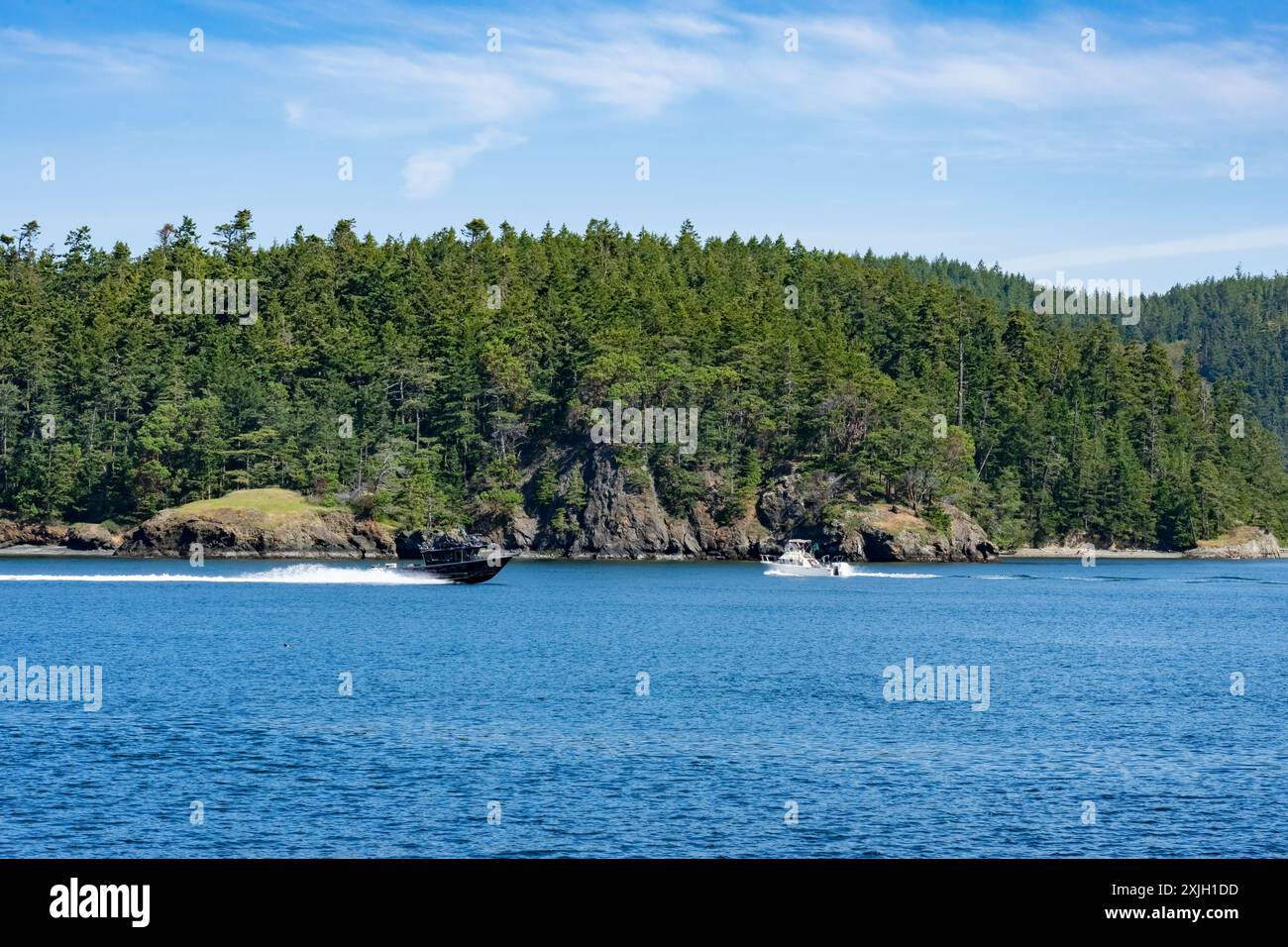 Deception Pass State Park, Washington, USA. Two speedboats passing near ...