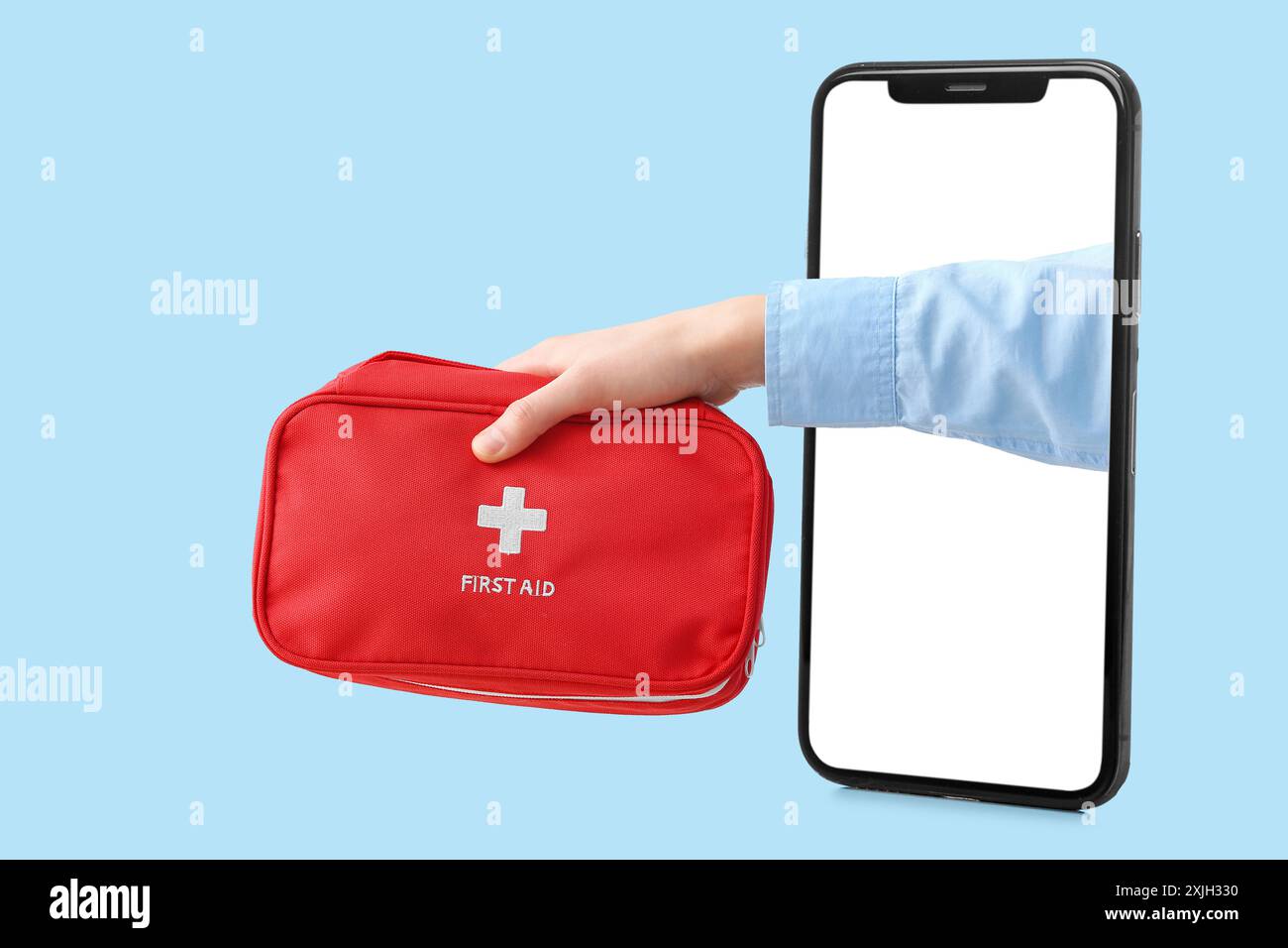Mobile phone and doctor's hand with first aid kit on light blue ...