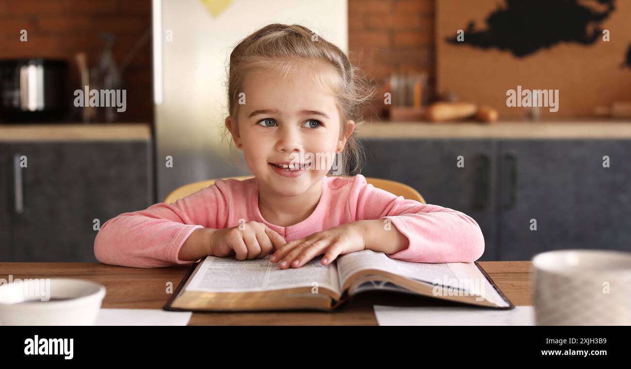 Little girl reading Bible at home Stock Photo - Alamy
