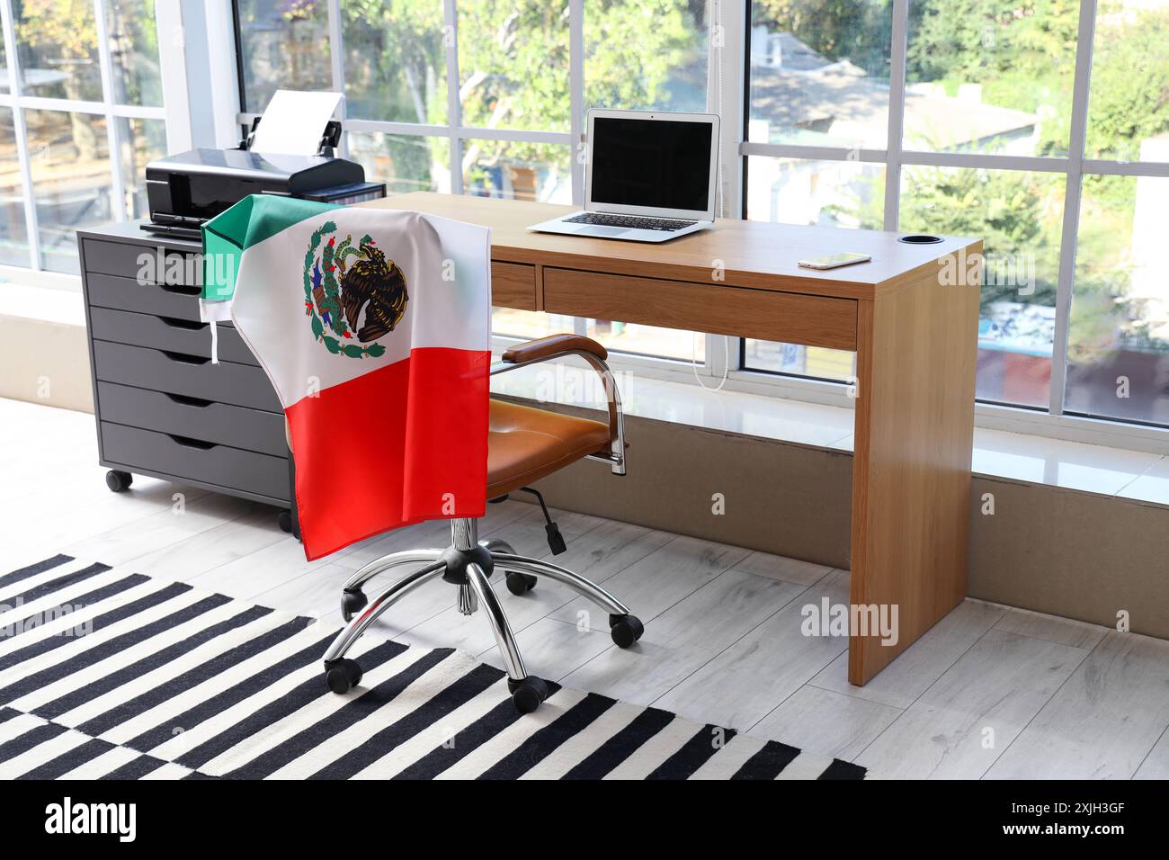 Mexican flag on chair in interior of office Stock Photo - Alamy