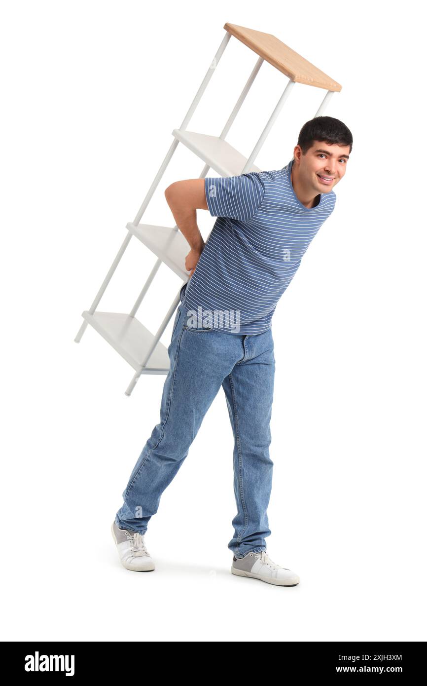Young man carrying shelf unit on white background Stock Photo - Alamy