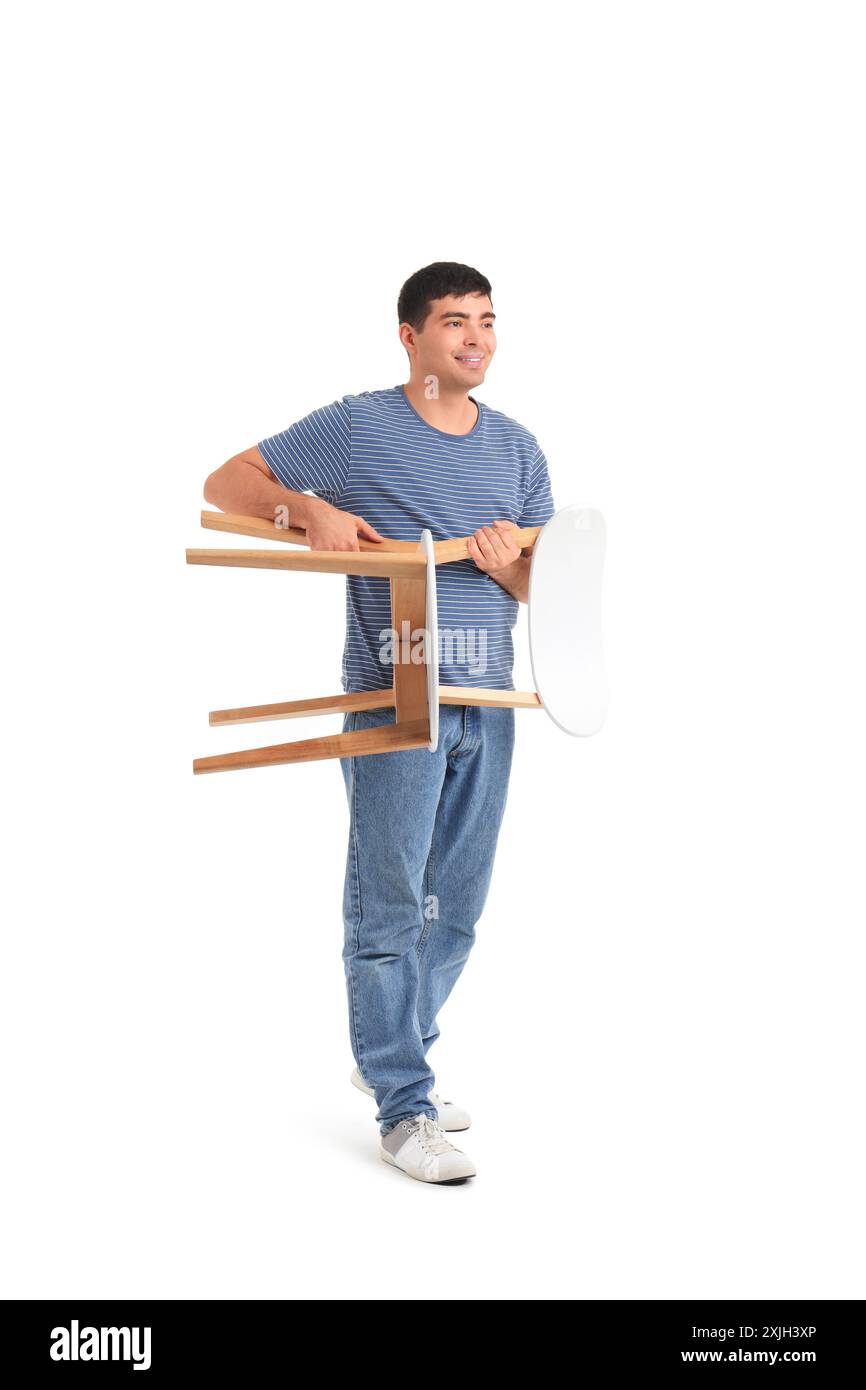 Young man carrying chair on white background Stock Photo - Alamy