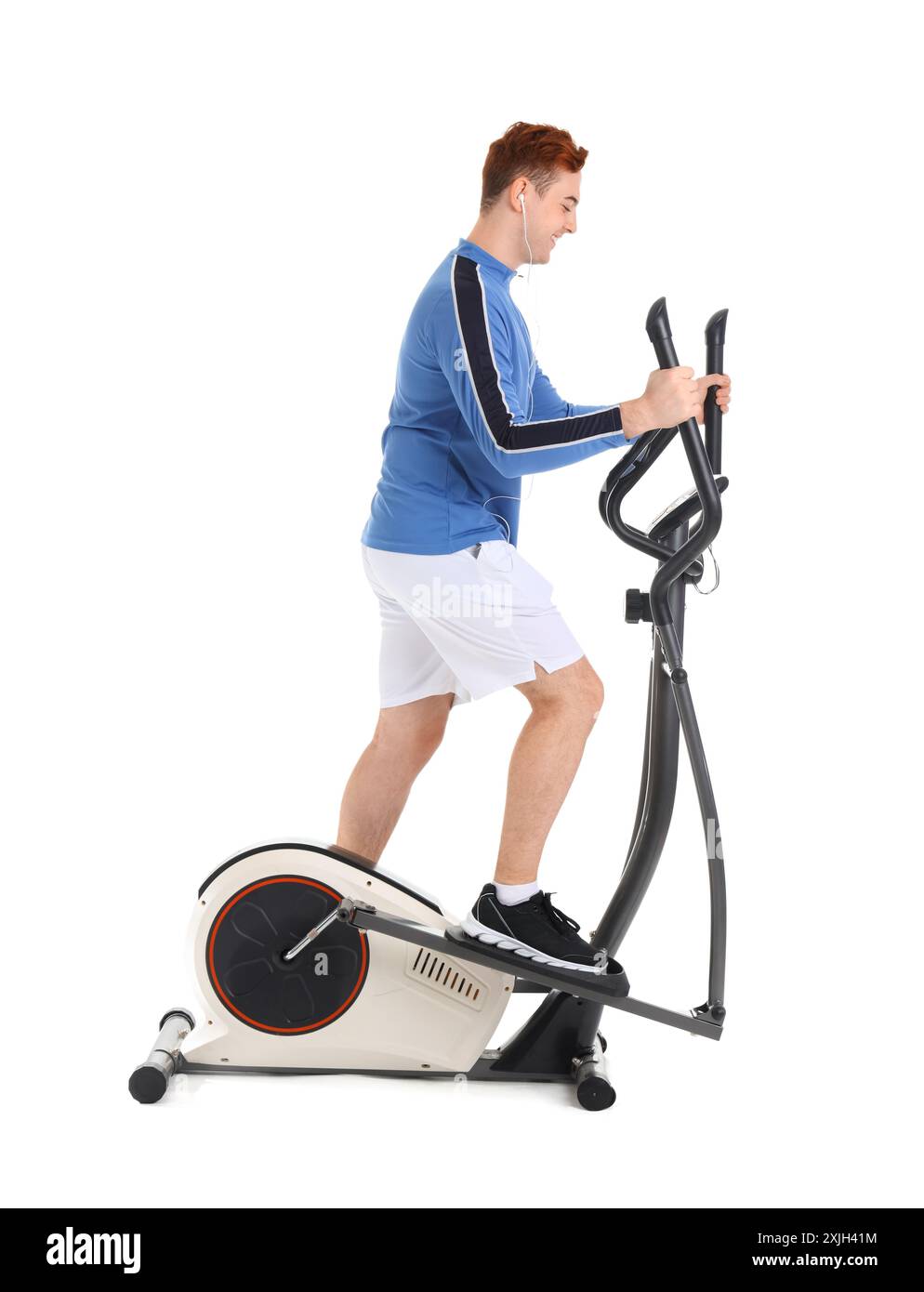 Sporty young man training on exercising bike against white background ...