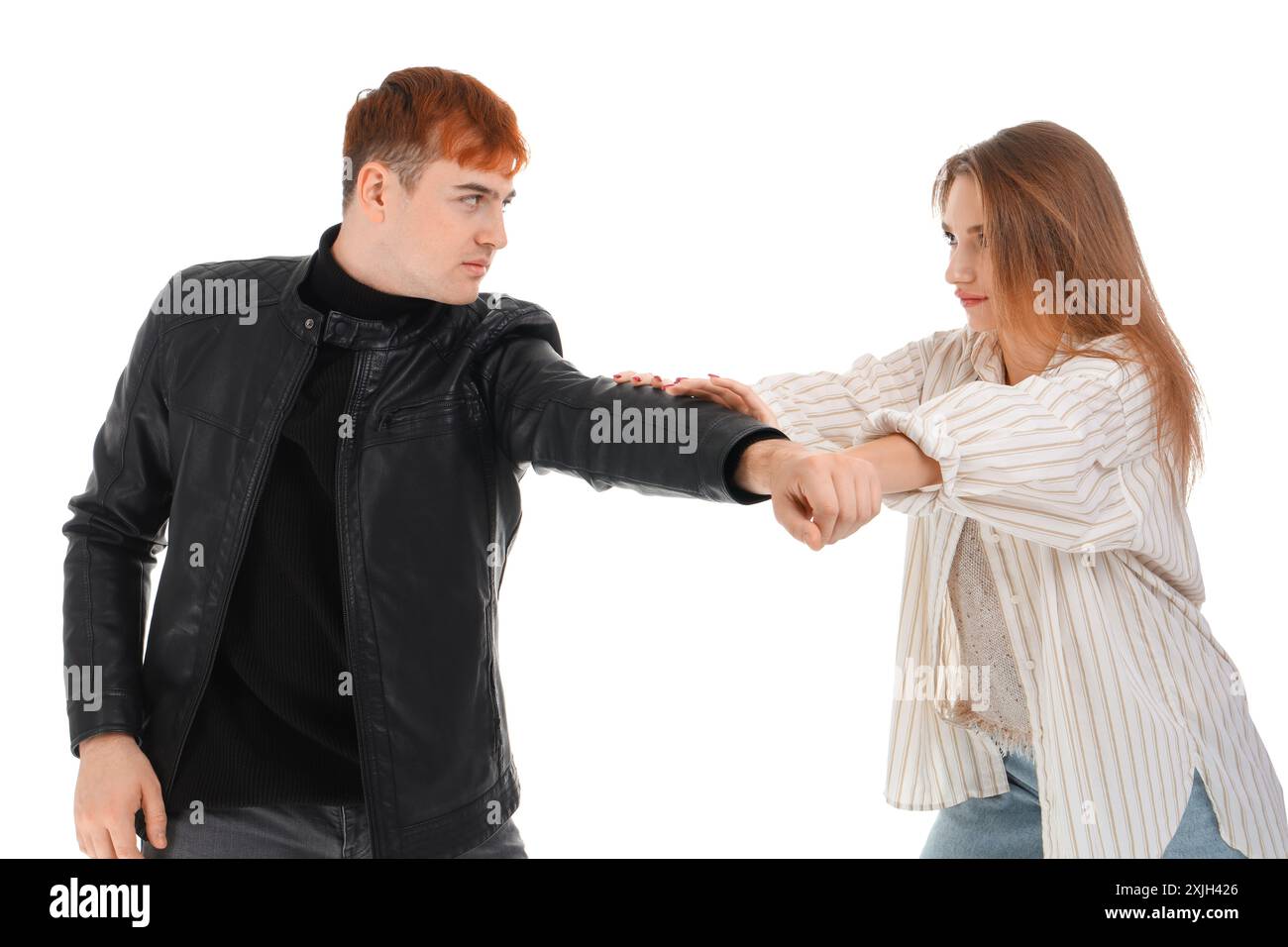 Young woman defending herself on white background Stock Photo - Alamy