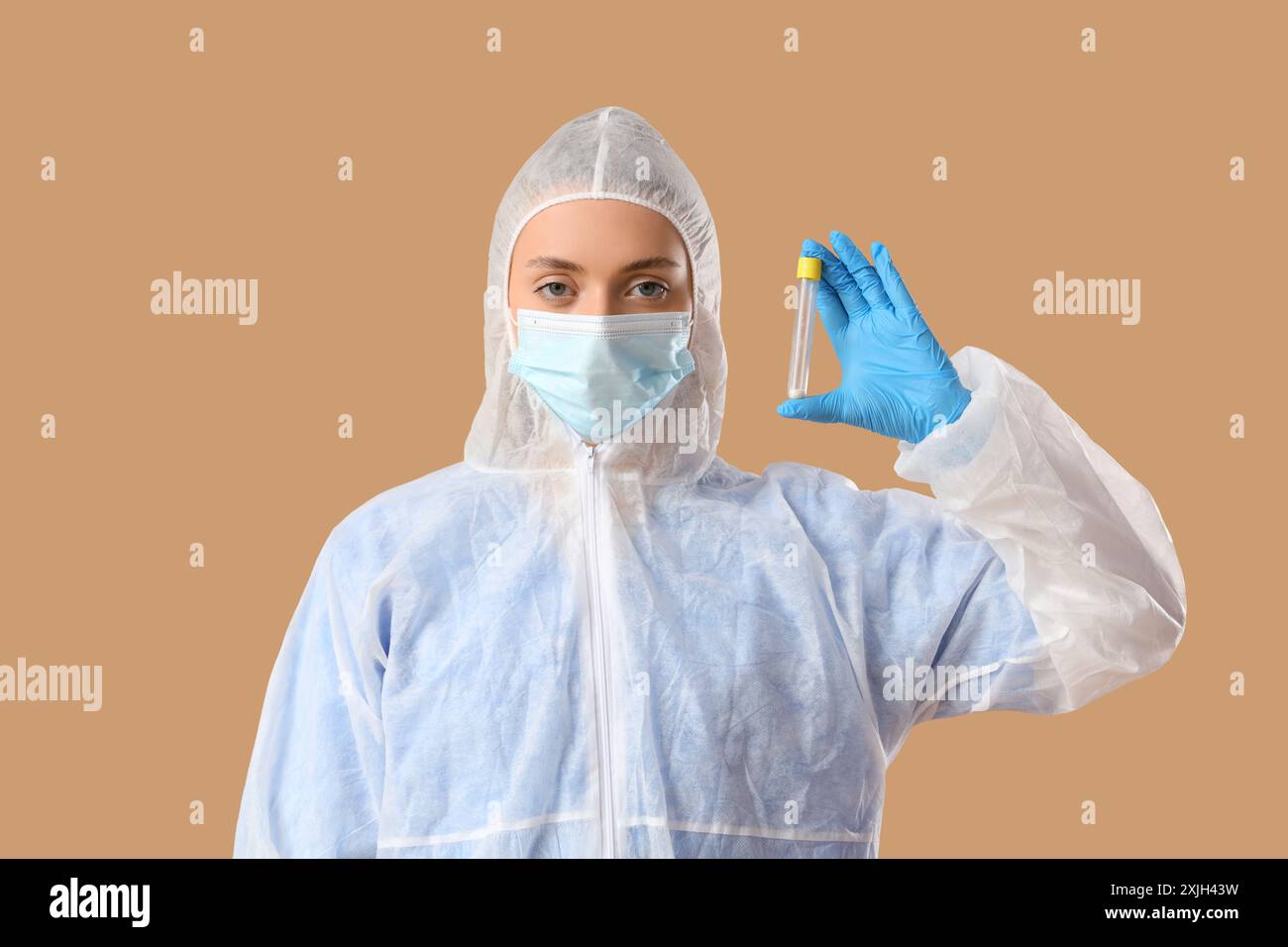 Portrait of laboratory worker with test tube on beige background Stock ...