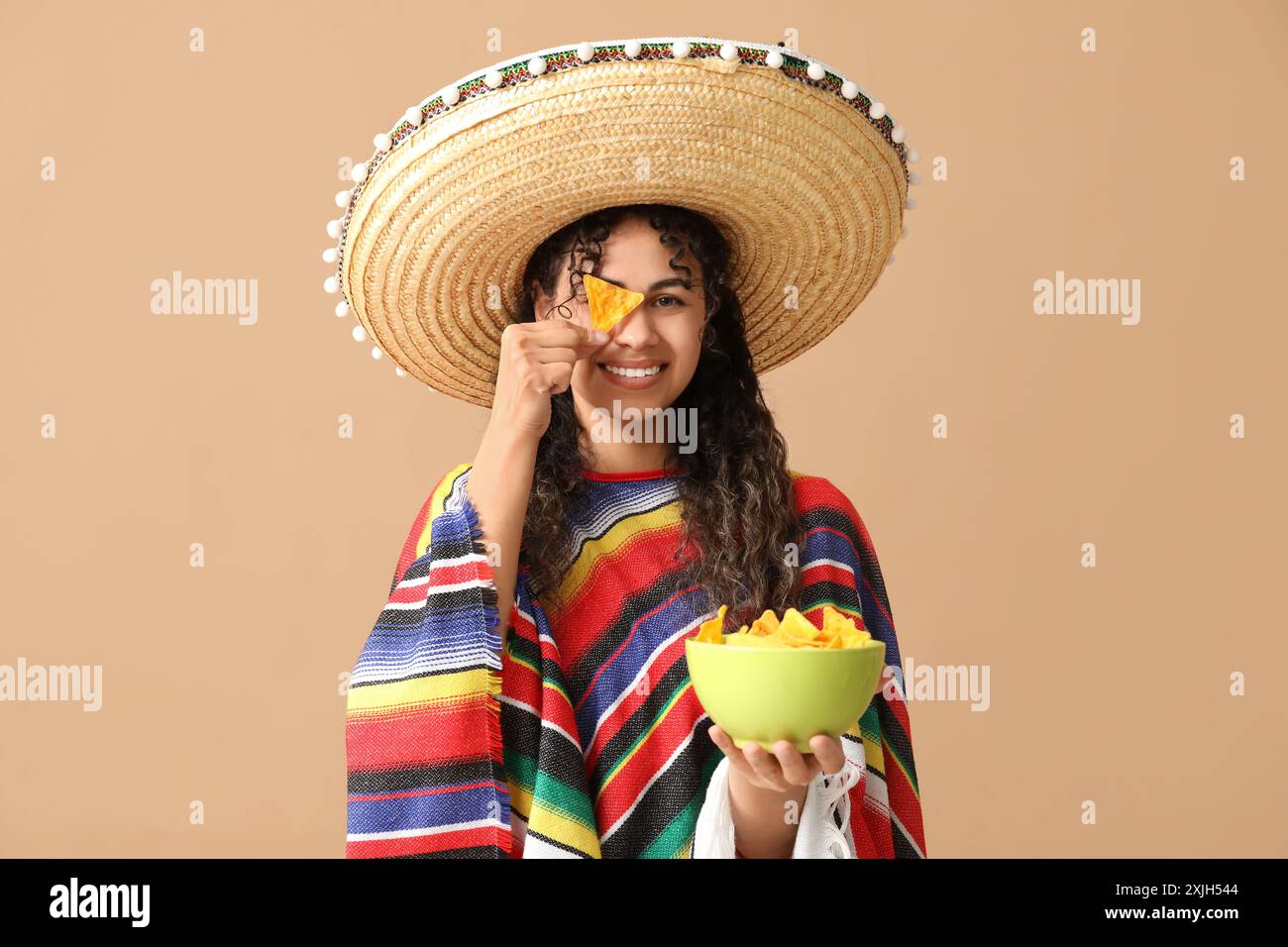 Beautiful young African-American woman in sombrero hat holding bowl ...