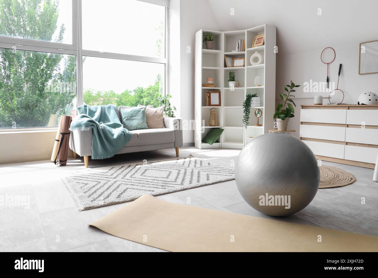 Interior of gym with sports equipment, sofa and drawers Stock Photo - Alamy