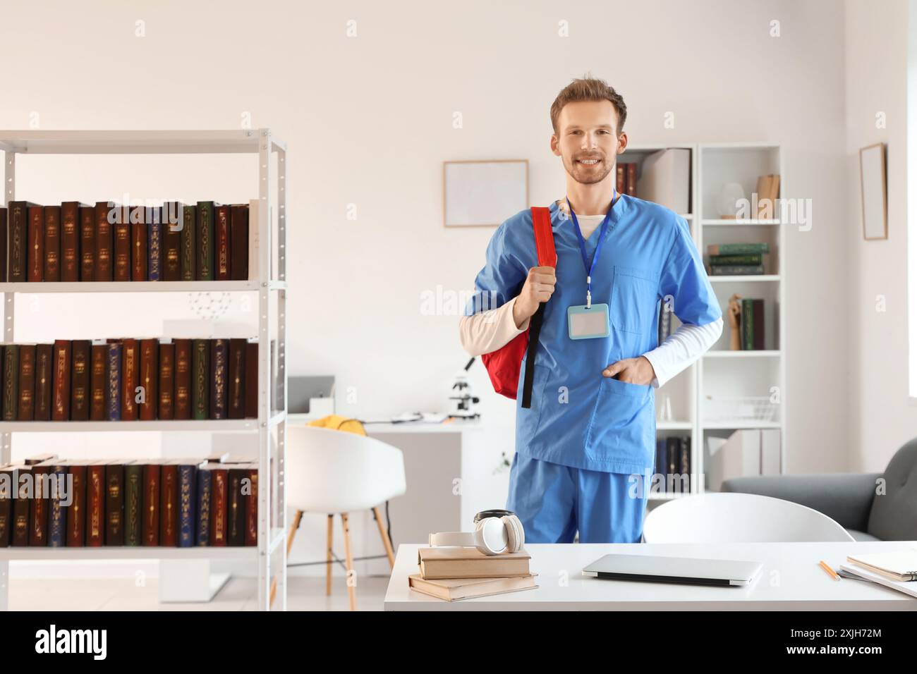 Male medical intern with backpack in library Stock Photo - Alamy