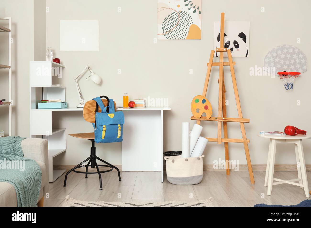Interior of children's room with backpack on table and easel Stock ...