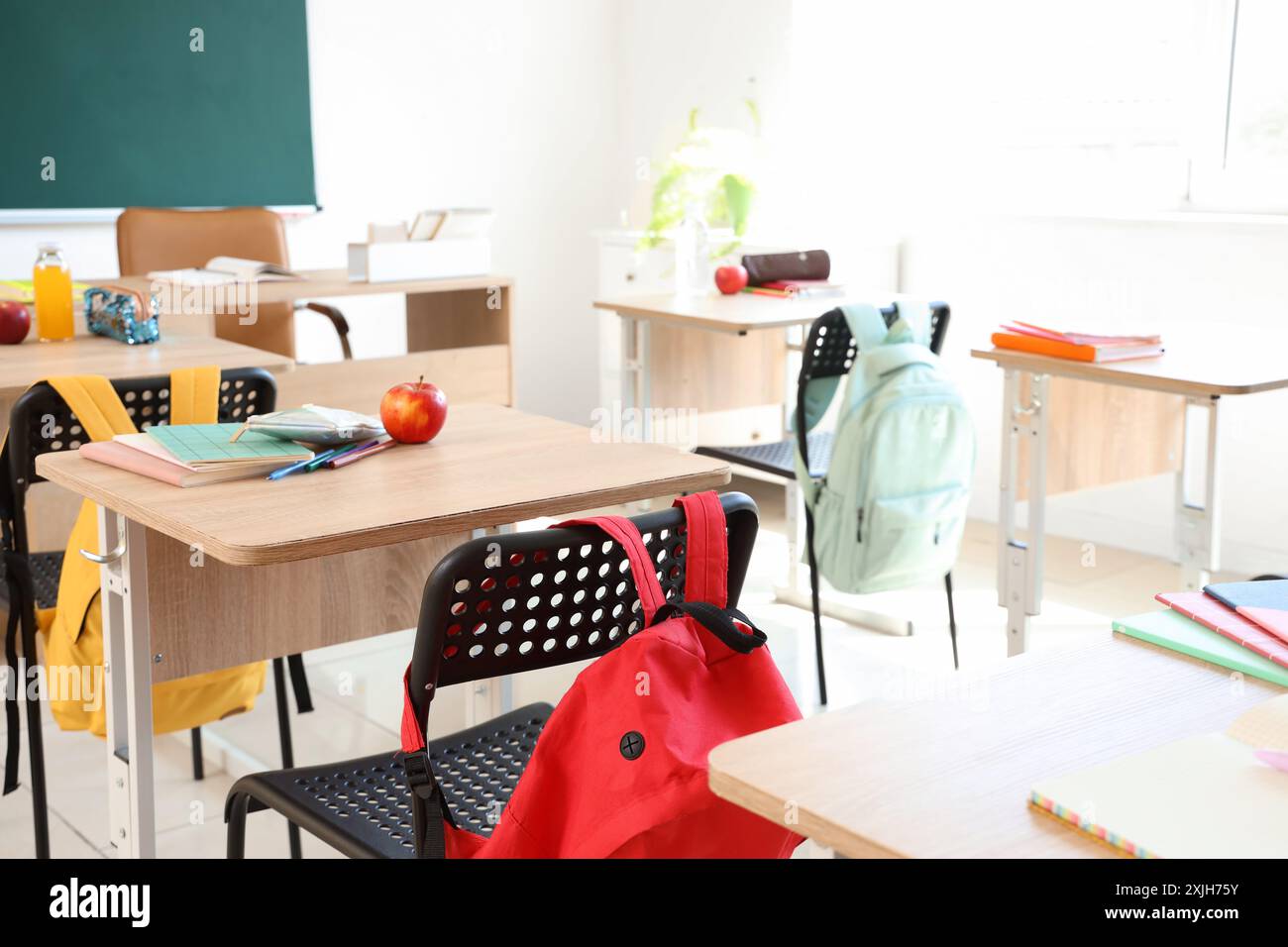 Backpack hanging in classroom hi-res stock photography and images - Alamy