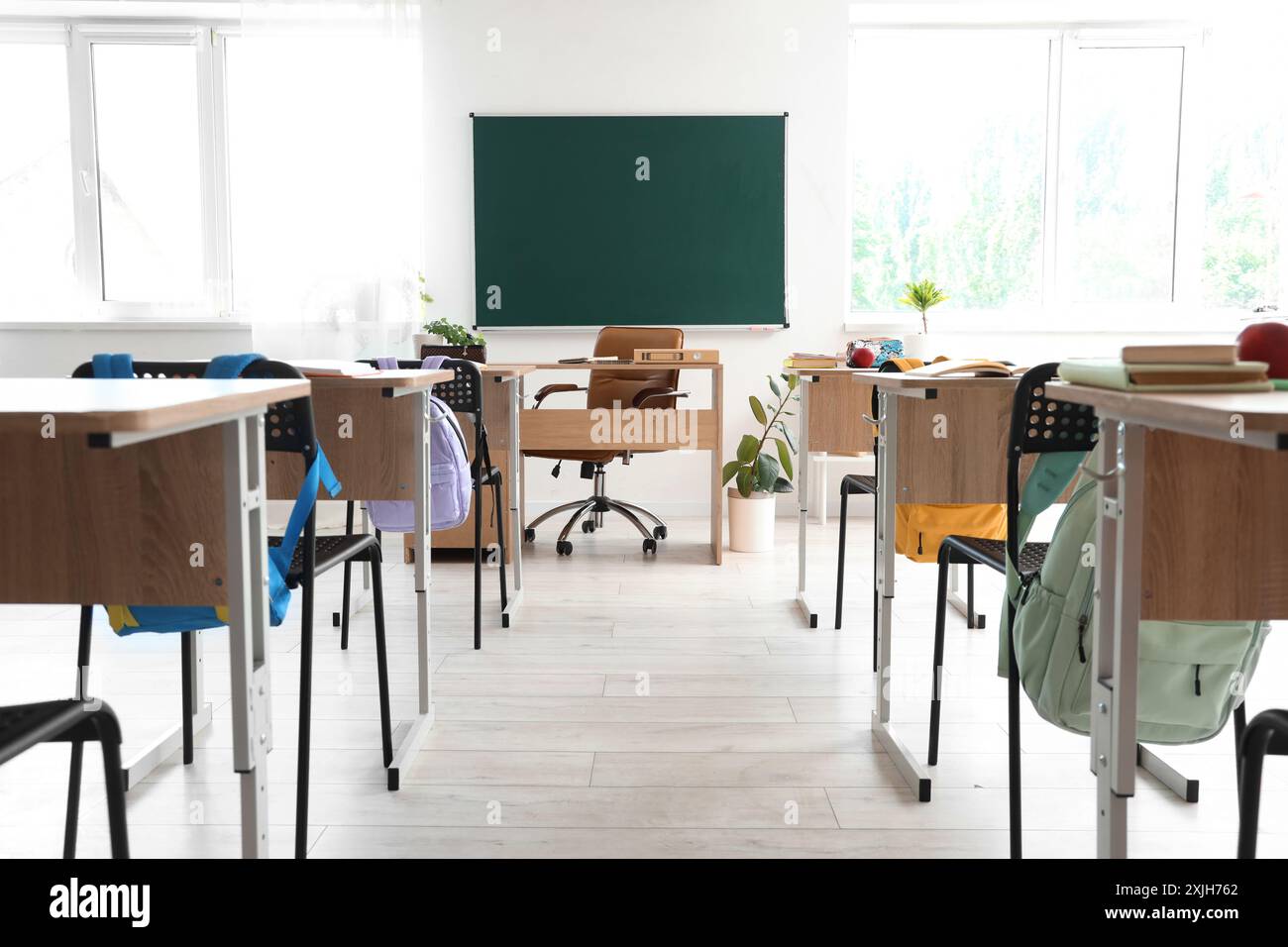 Interior of empty classroom with desks and chalkboard Stock Photo - Alamy
