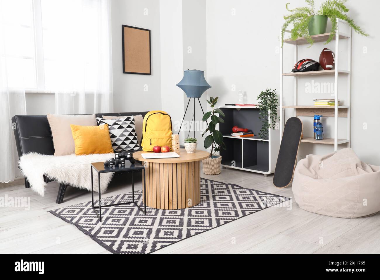 Interior of children's room with sofa and backpack on table Stock Photo ...
