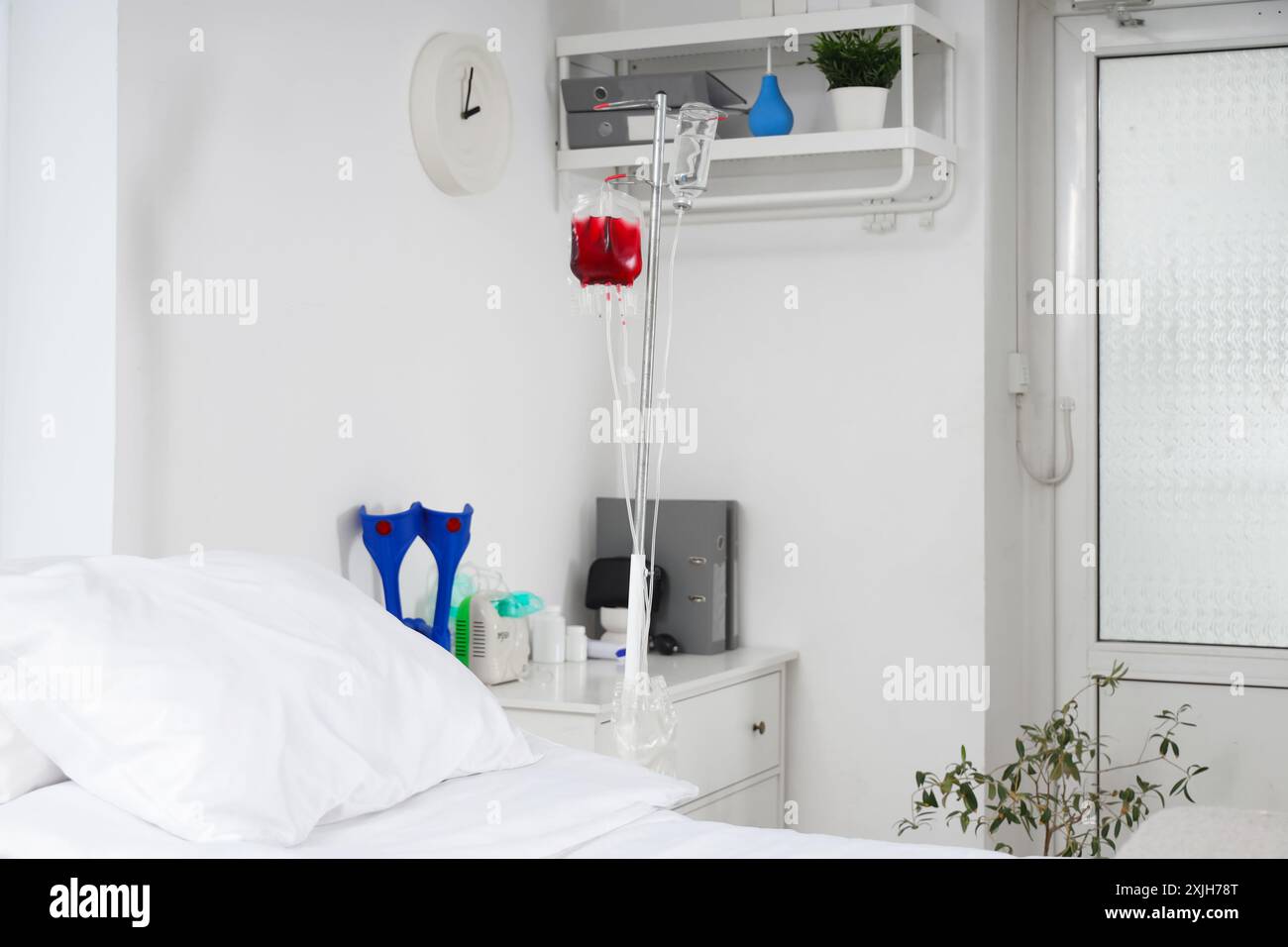 Bed with drip stand in hospital ward Stock Photo - Alamy
