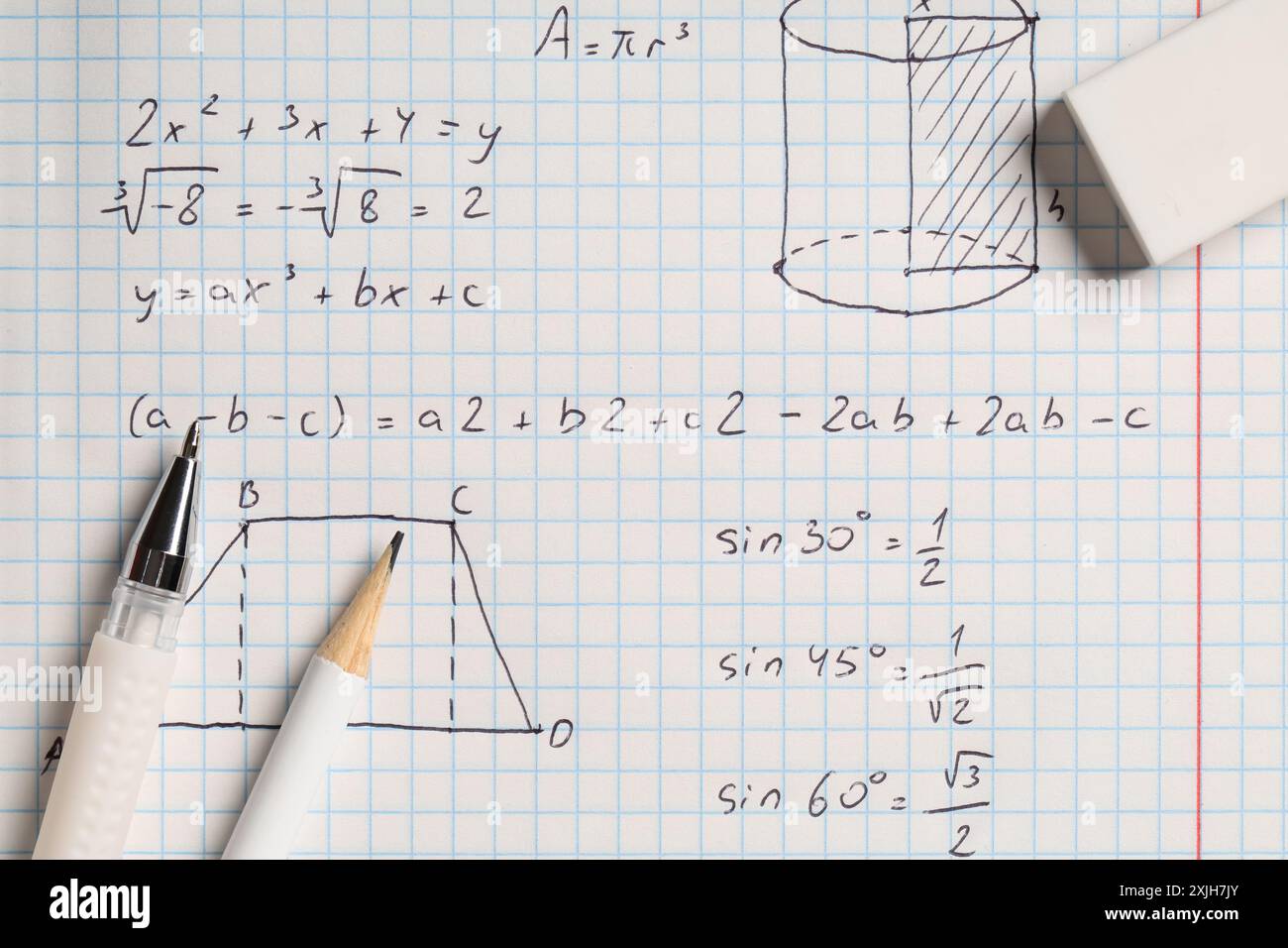 Copybook with handwritten maths formulas and stationery as background ...