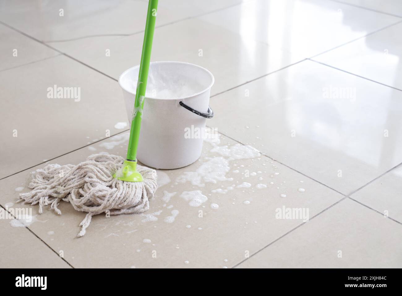 Wet mop with bucket on floor in dorm room, closeup Stock Photo - Alamy