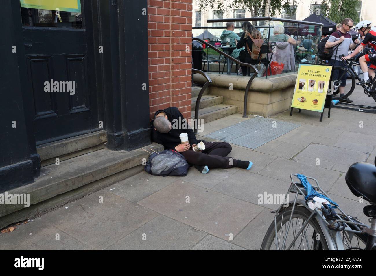 Homeless person sleeping on street pavement in Sheffield city centre ...