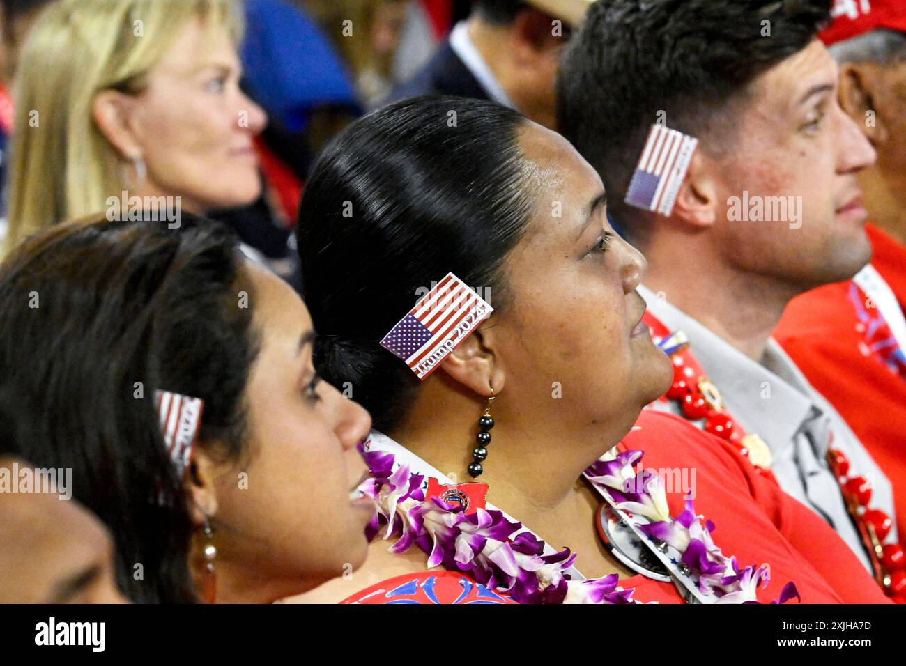 Delegates wear American flag bandages over their ears to represent ...