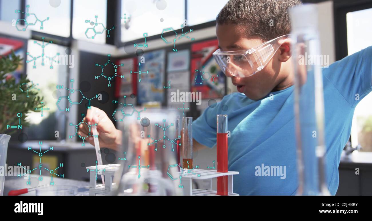 Chemical formulas and molecular structures over boy conducting science experiment in lab image ...