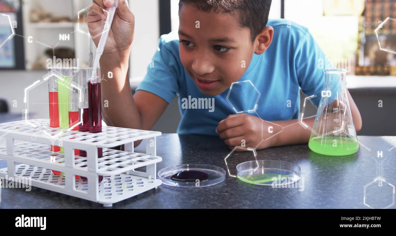 Conducting science experiment, boy observing chemical reactions over ...