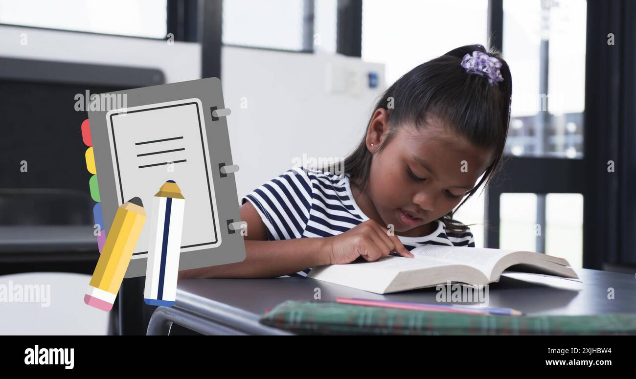 Studying at desk, young girl reading book with notebook and pencil image. education, school ...