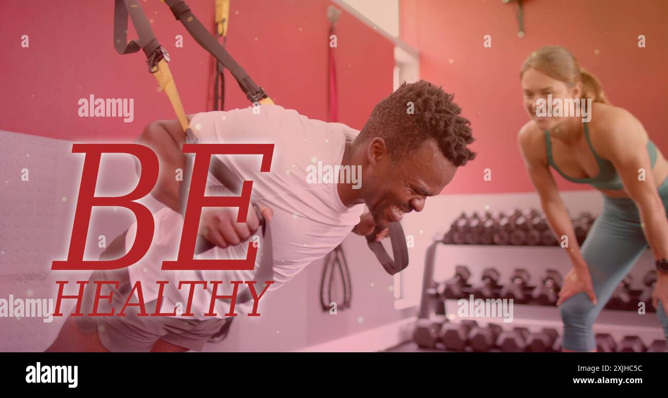 Image of be healthy text over diverse man and woman exercising in gym ...