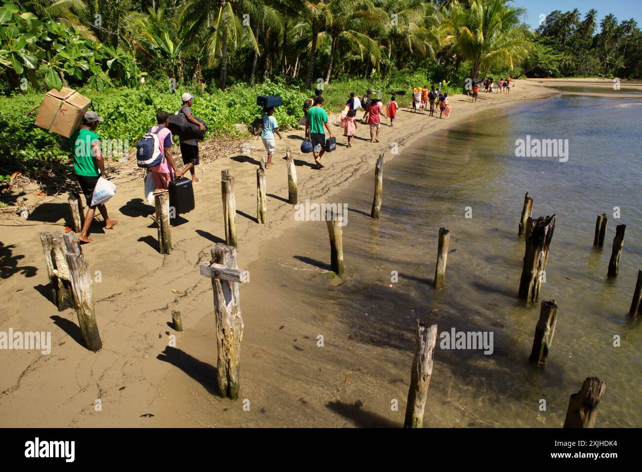Villagers carry tourist's luggage arriving by boats, as they are ...