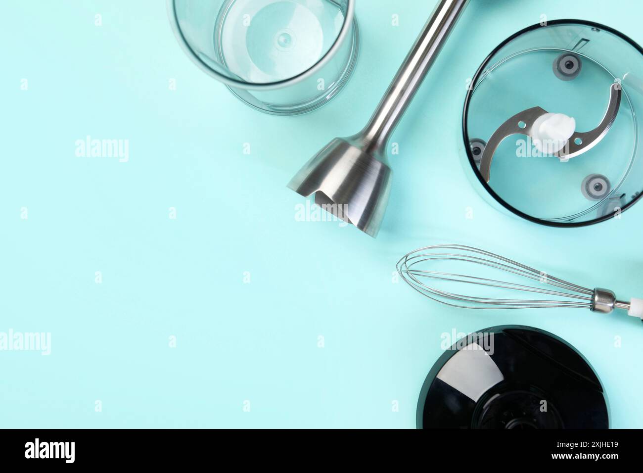 Hand blender kit on light blue background, flat lay. Space for text ...