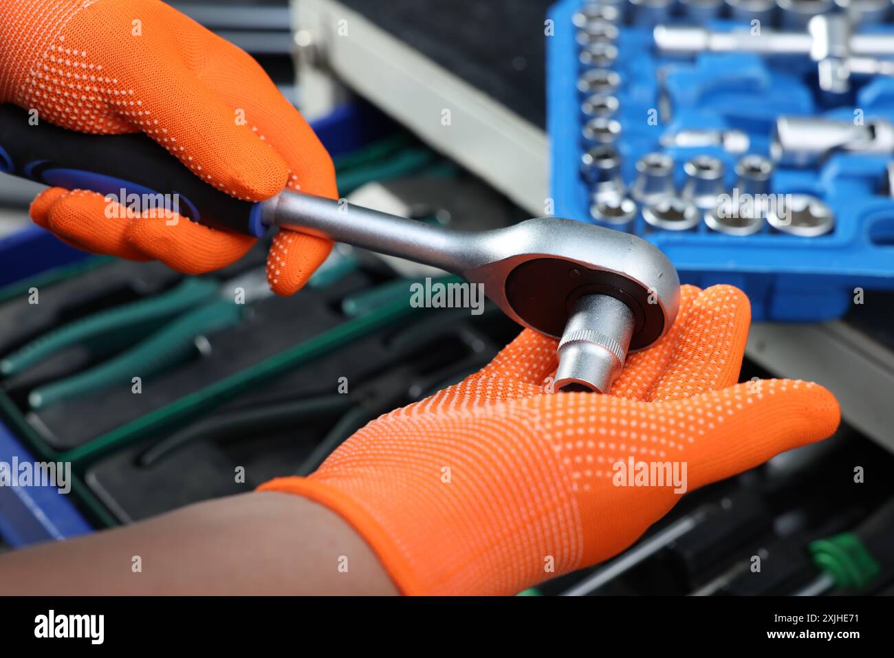 Auto mechanic with torque wrench and different tools at automobile ...